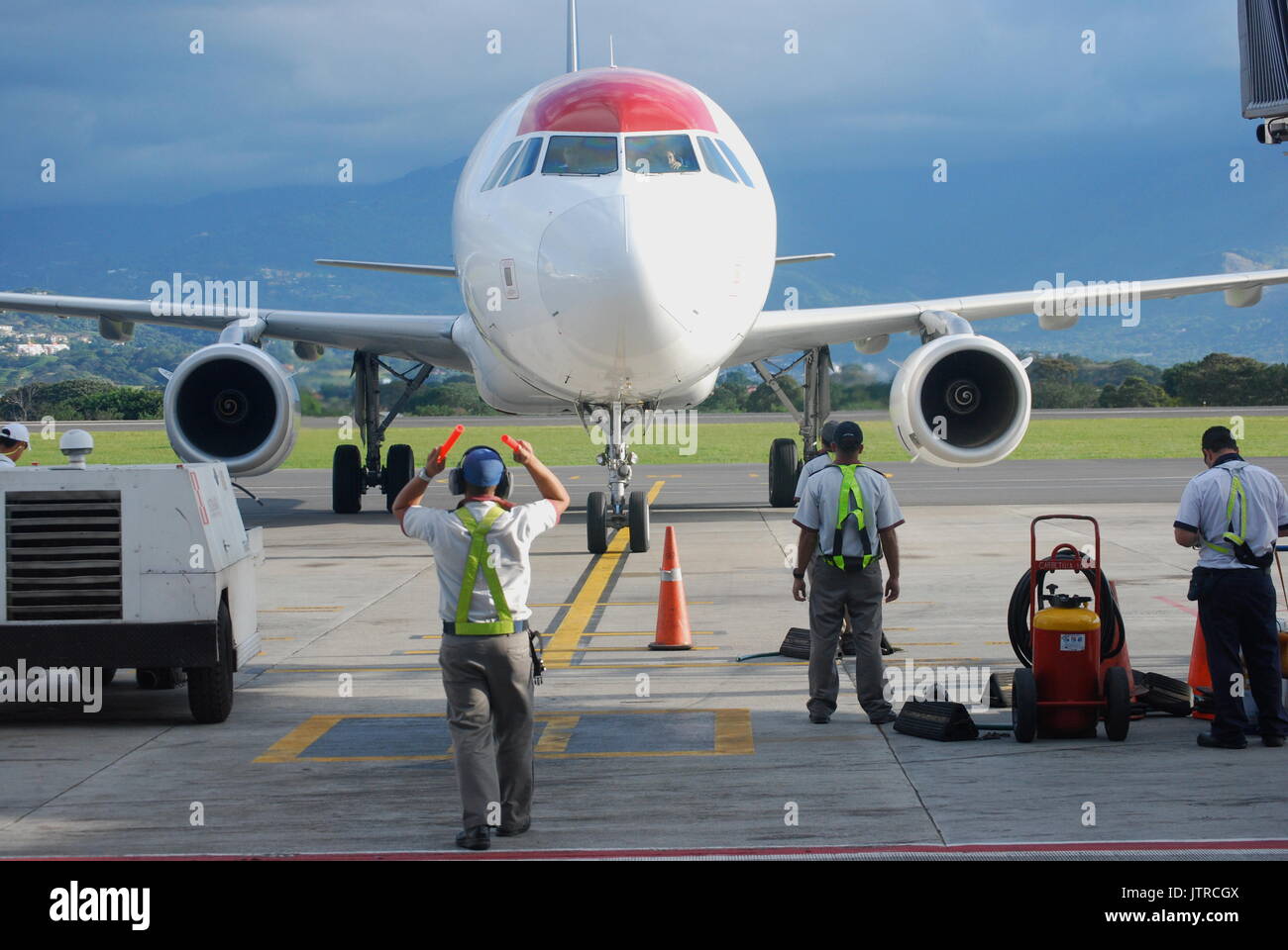 Ground crew working and docking airplane sequence Stock Photo - Alamy