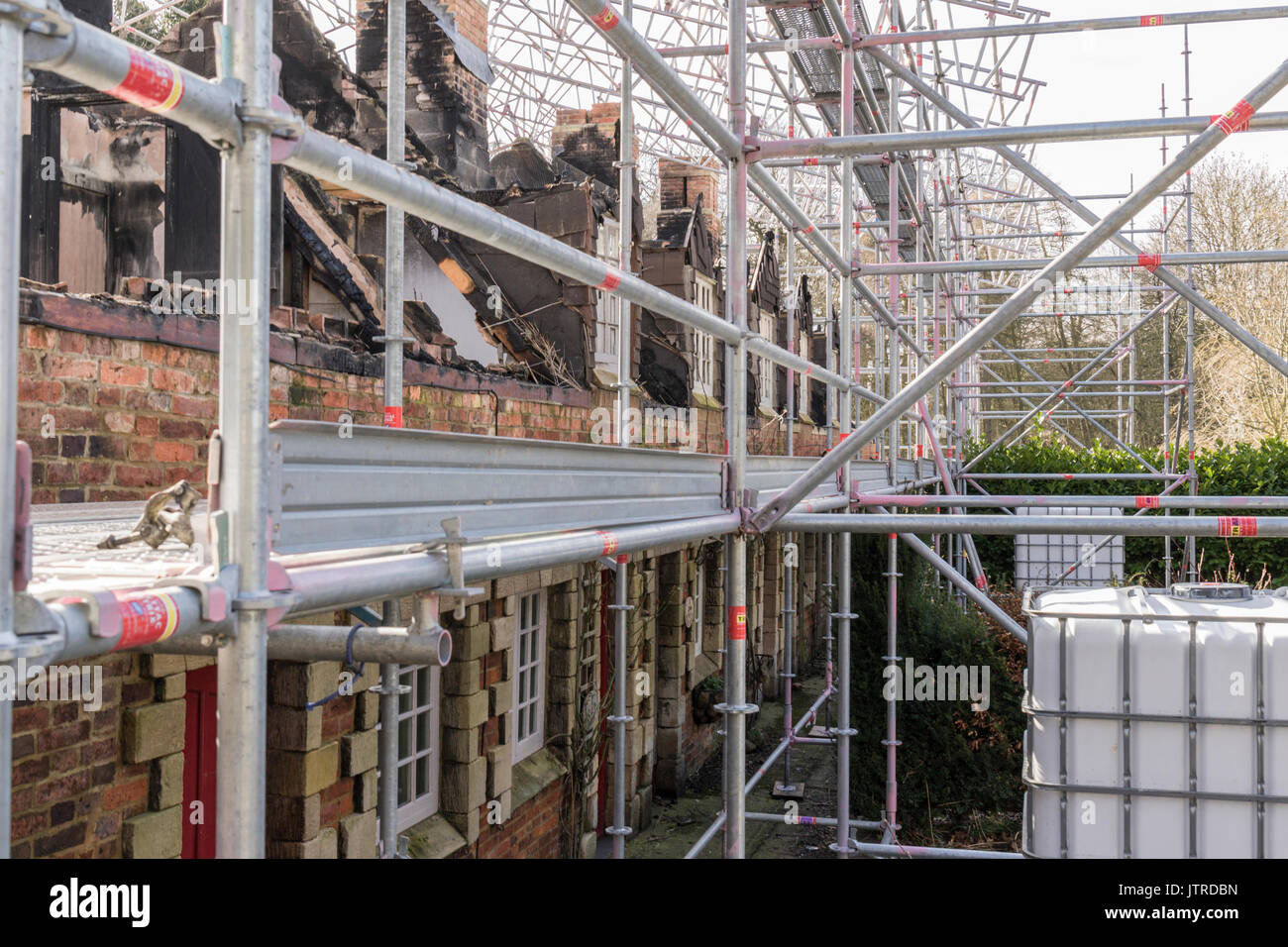 Scaffolding covering fire damaged houses, undergoing renovation Stock ...