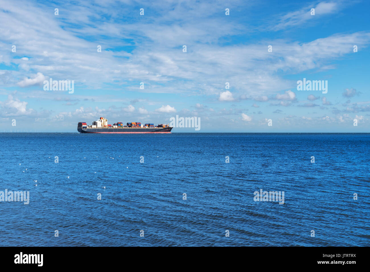 large container cargo ship on wide blue ocean Stock Photo - Alamy
