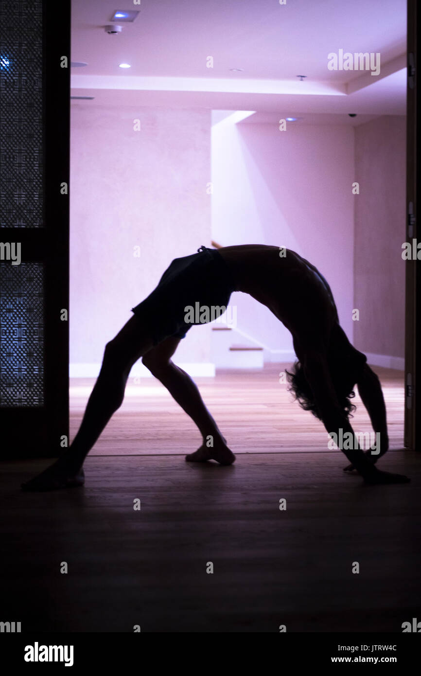 Yoga teacher doing backbend bridge flexibility and strength asana ...