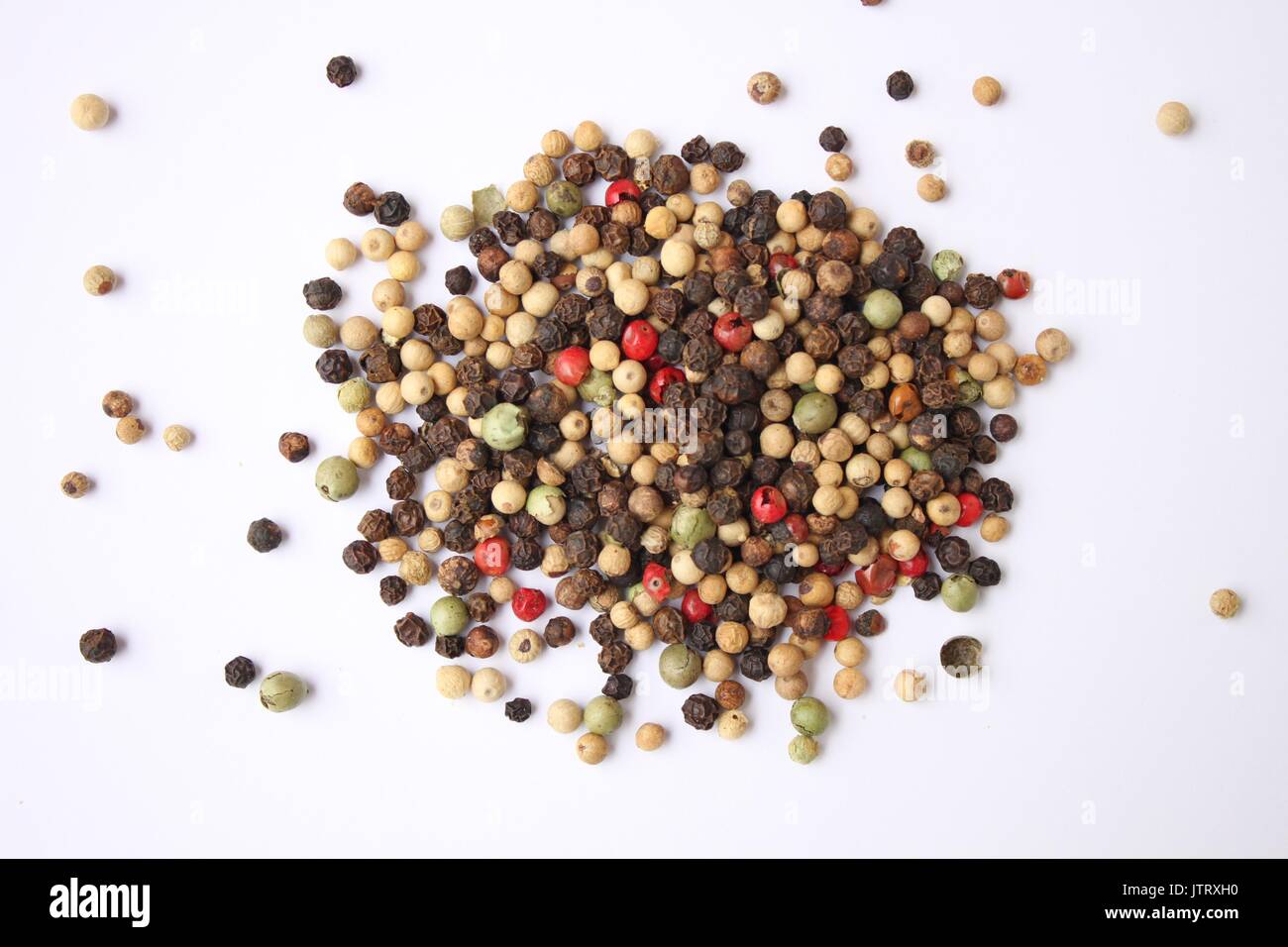 Multicolor peppercorns on white background Stock Photo - Alamy