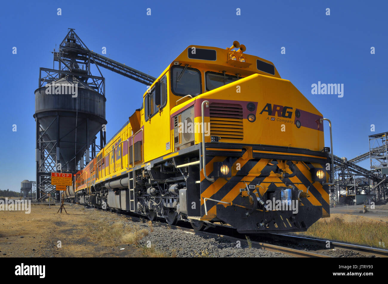 Coal mine train taking on crushed coal for transportation to a port ...