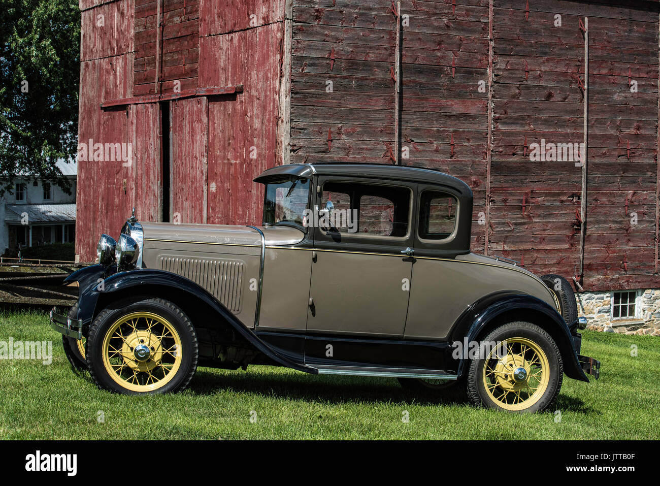 Antique, classic car parked alongside barn in countryside Stock Photo ...