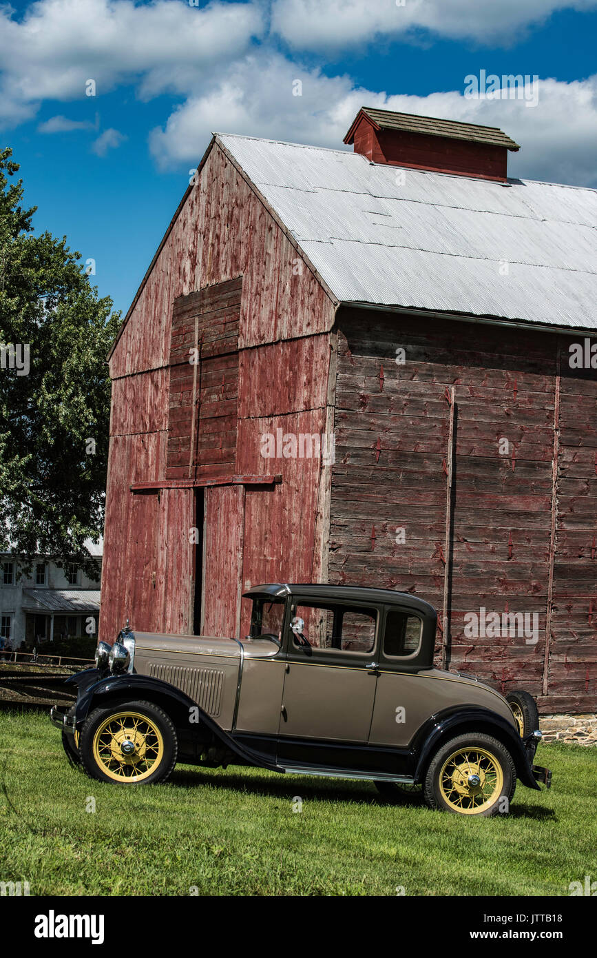 Antique, classic car parked alongside barn in countryside Stock Photo ...
