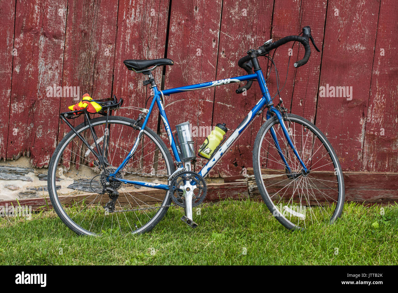 Bicycle resting against barn door Stock Photo - Alamy