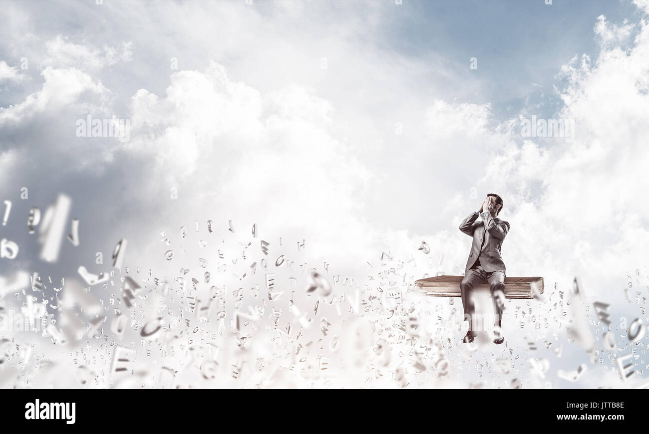 Young man floating in sky and do not want to see anything Stock Photo ...