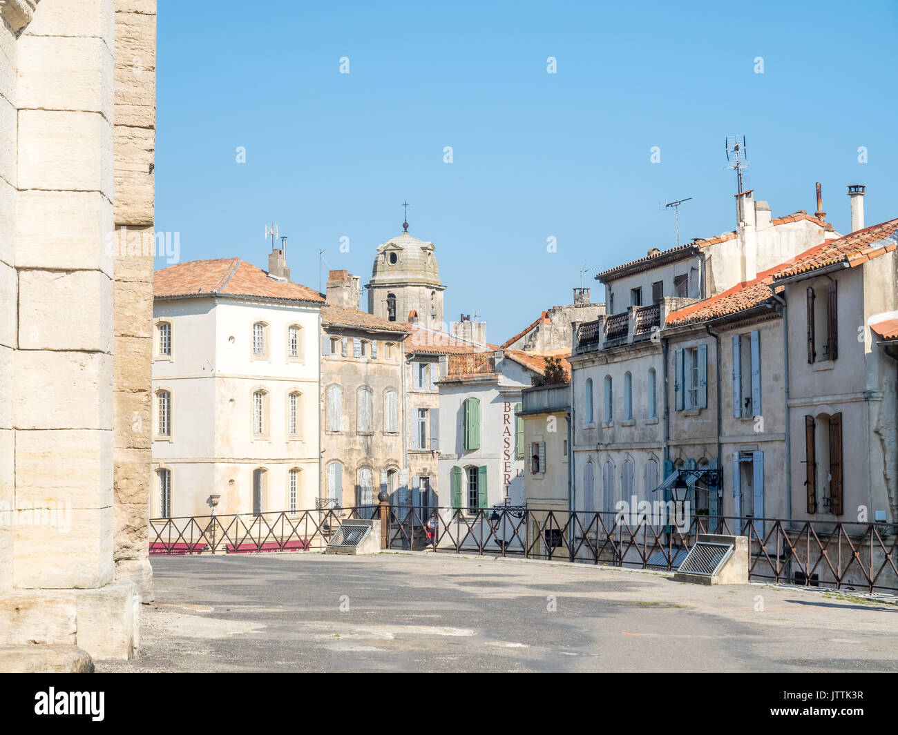 Buildings scene near Amphitheater in Arles, France, under clear blue ...