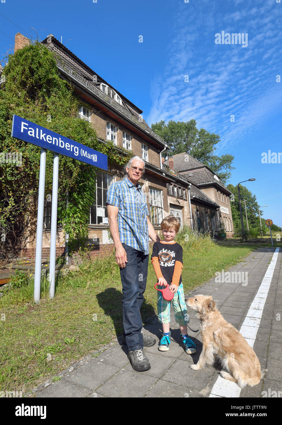 Thomas Wittstock standing with his son Adrian and dog Laika outside his ...
