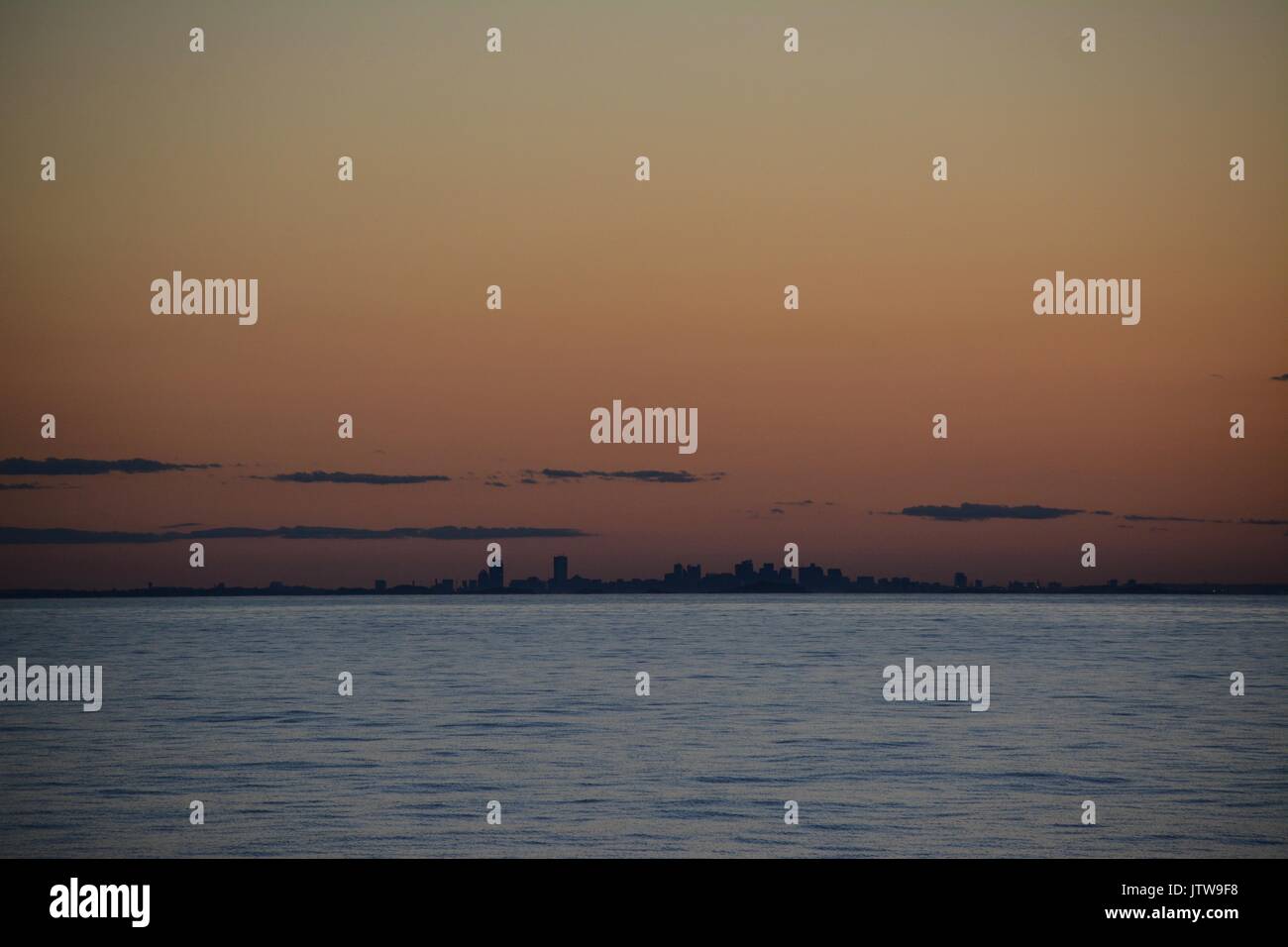 The Boston, Massachusetts skyline at sunset see from Massachusetts Bay ...