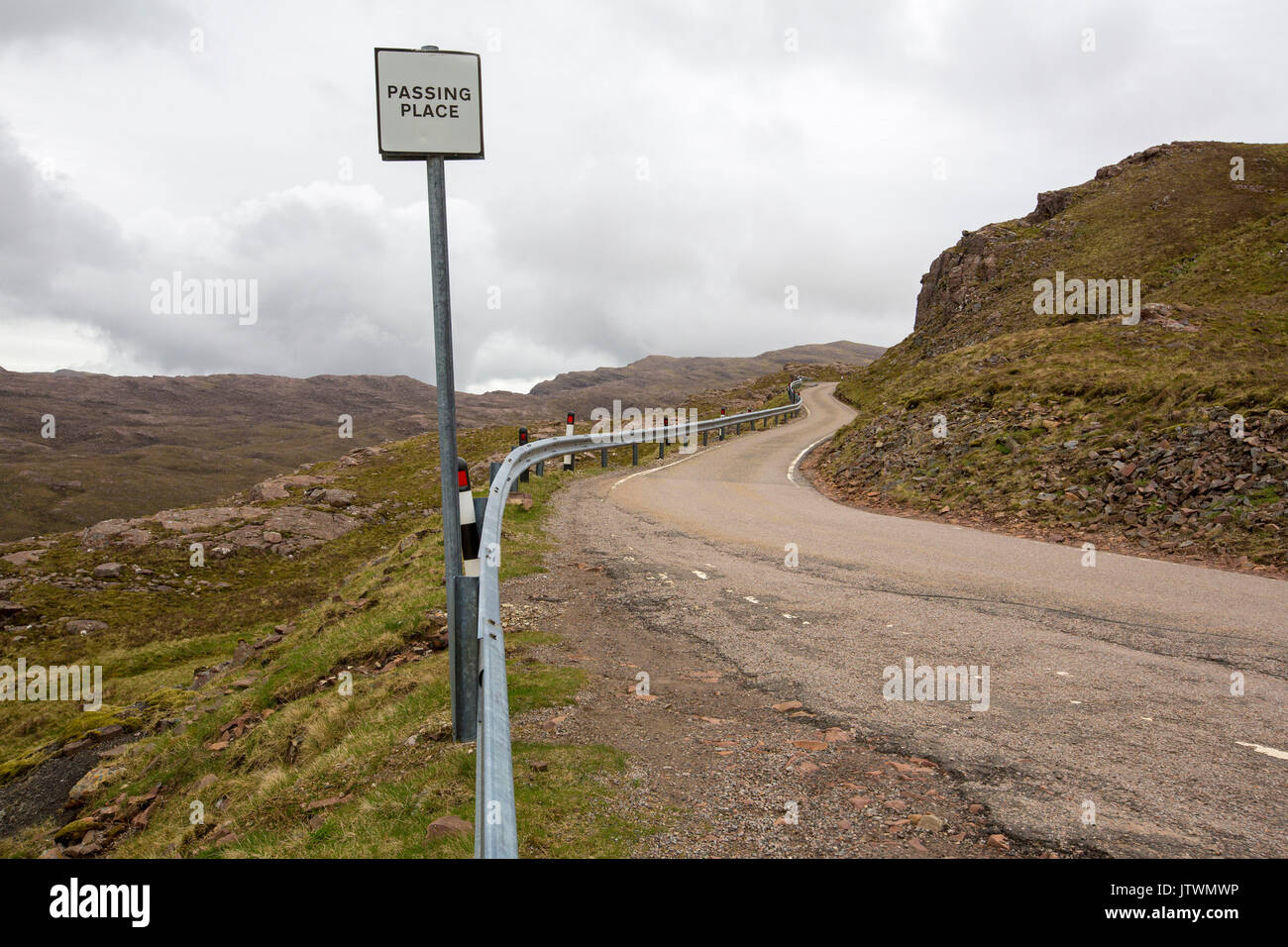 Rugged mountainous landscape with narrow winding road over cattle pass ...