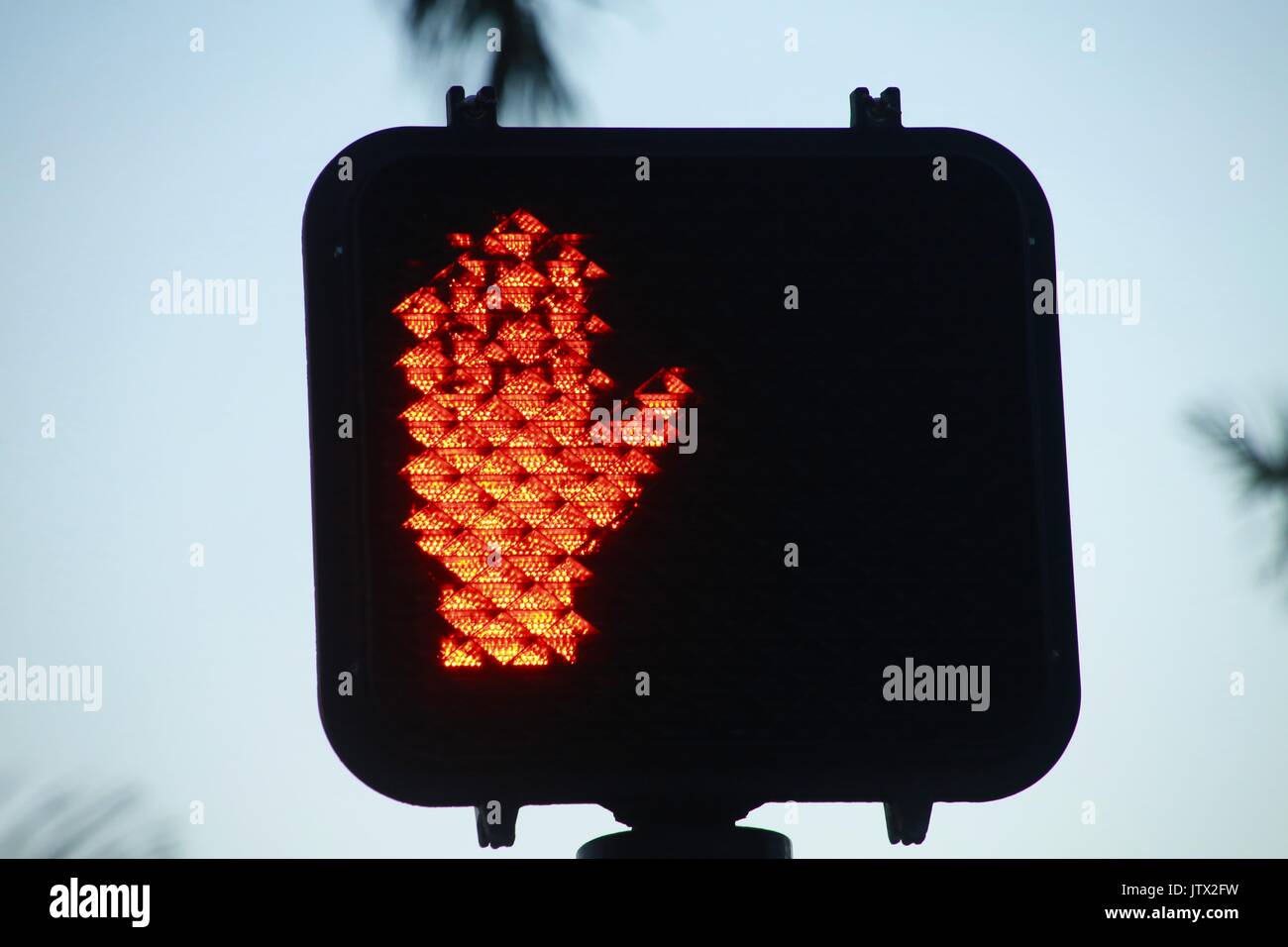 Red Illuminated Stop Don't Walk Hand Up Signal at Traffic Intersection ...