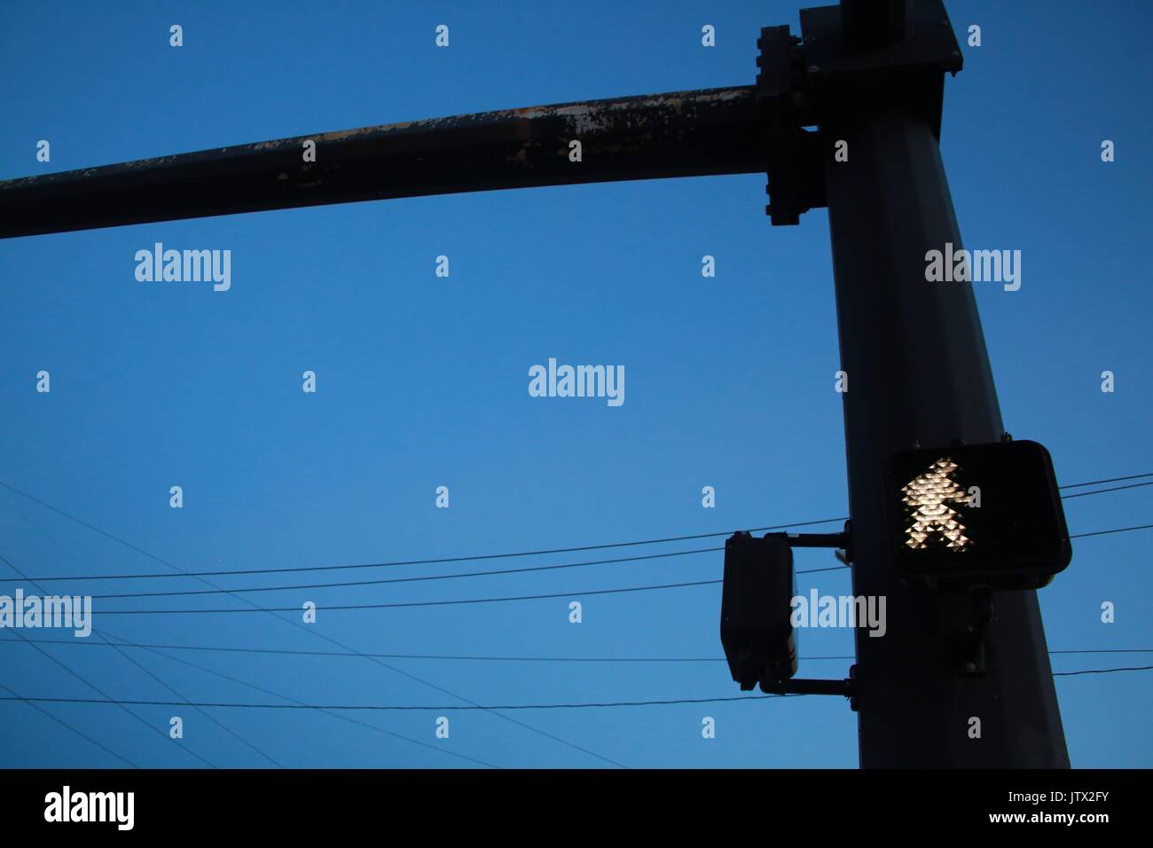 White Illuminated Walk Symbol on Traffic Light Post at Intersection ...