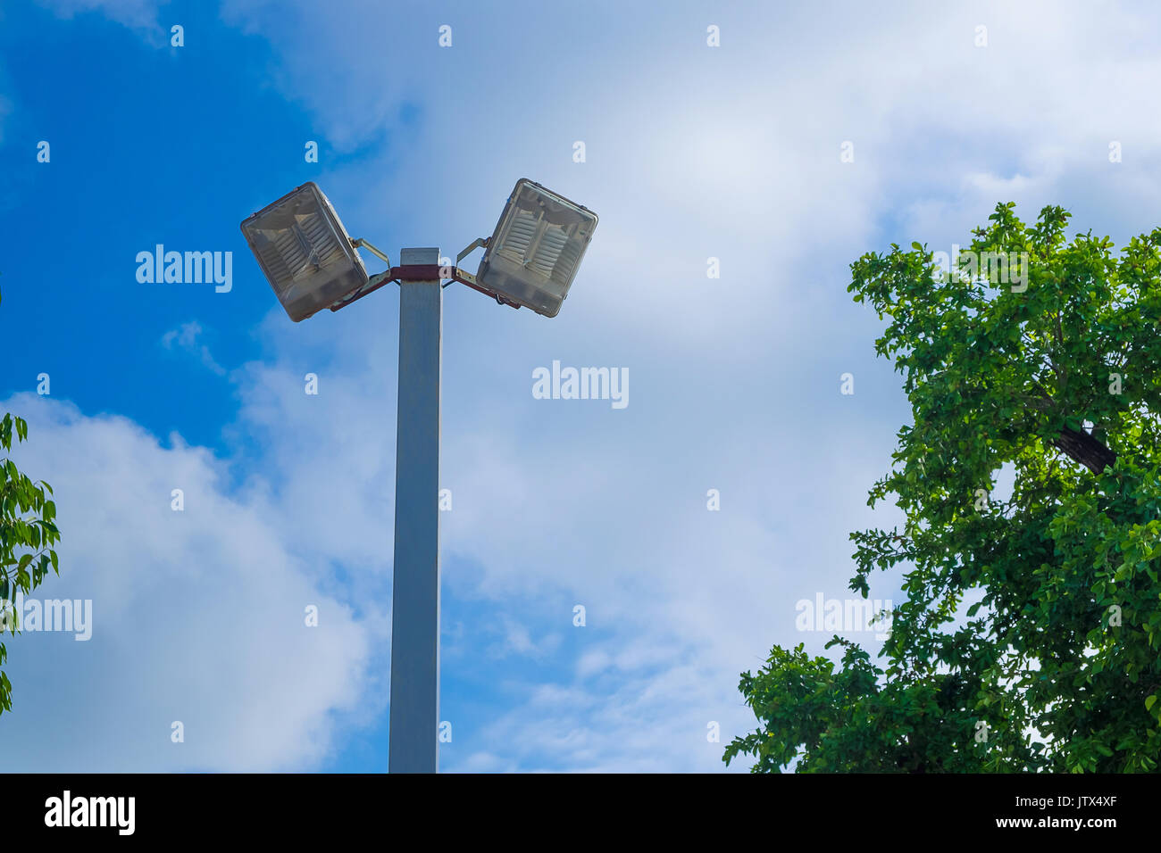 Lamp post electricity industry with blue sky background and tree ...