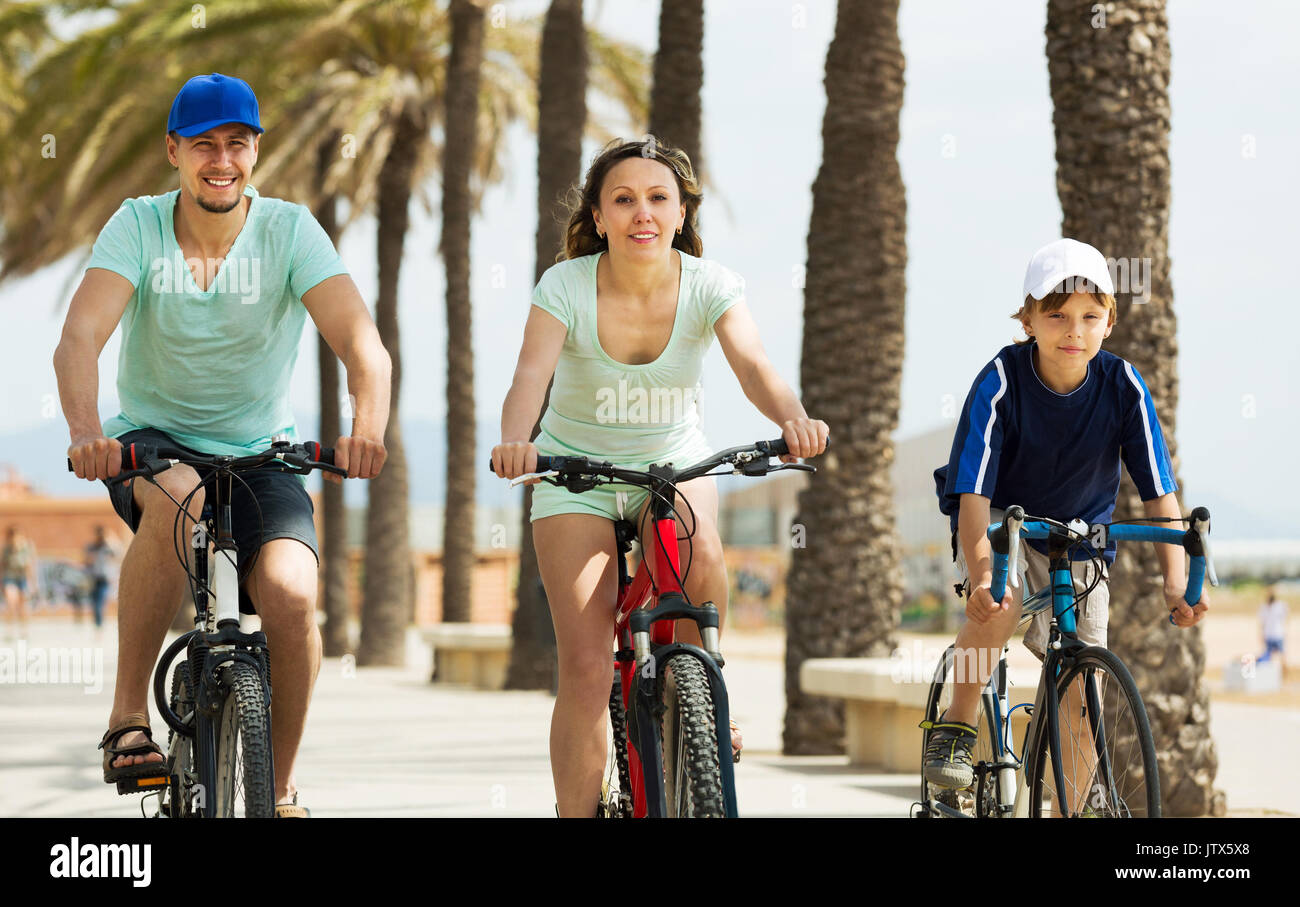Happy family with son riding bicycles and smiling together Stock Photo ...