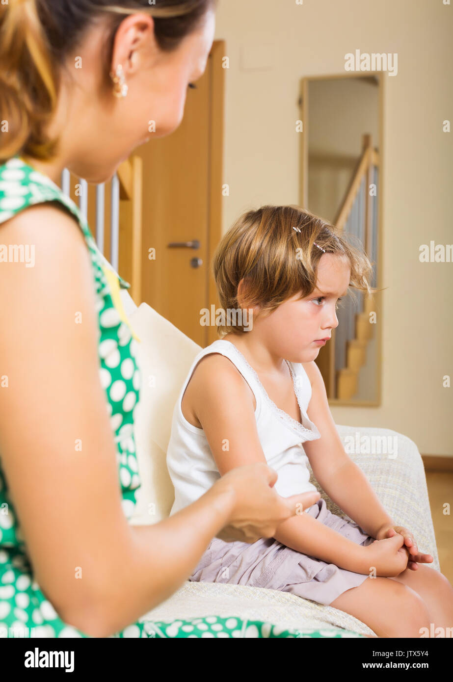 Woman berating little daughter in home interior Stock Photo - Alamy