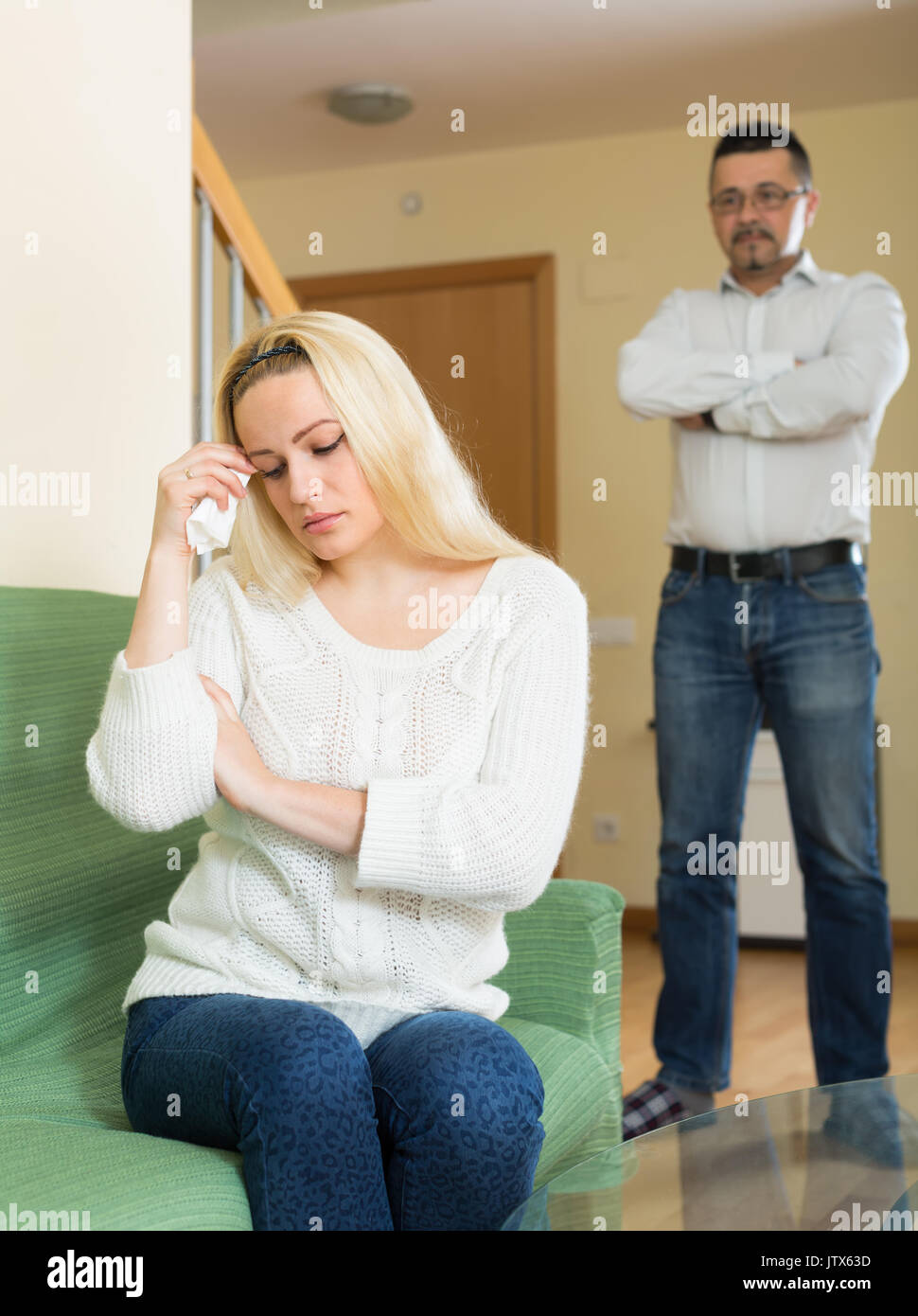 Family quarrel. Sad man and crying young blonde woman after quarrel in ...