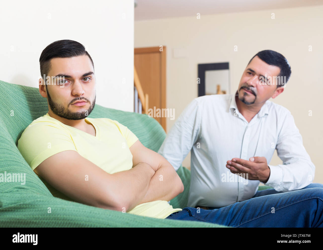 Two male adults arguing about something indoors after quarrel Stock ...