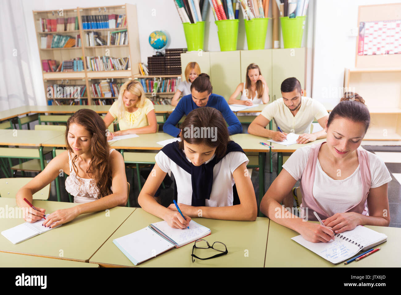 Group of young students studying in the classroom Stock Photo - Alamy