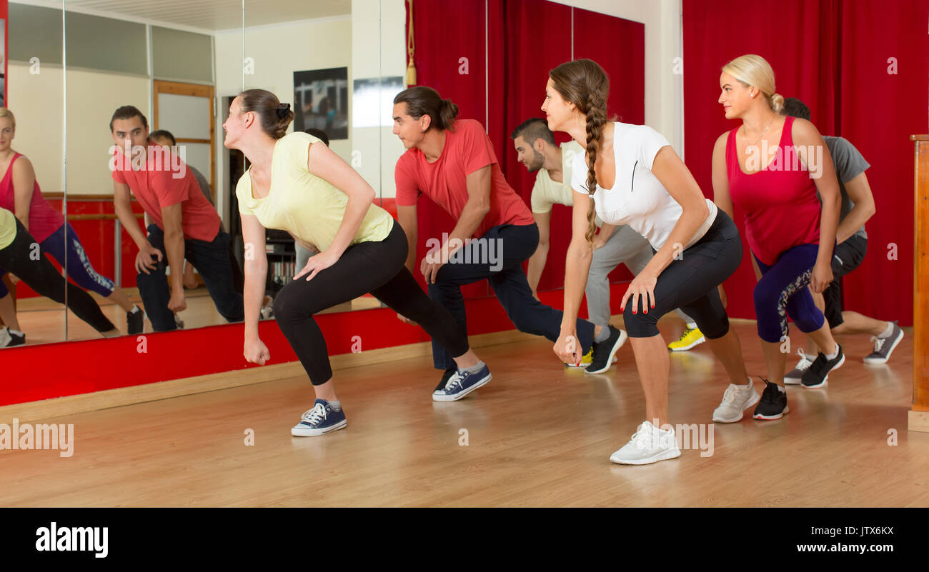 Group of young smiling people dancing active dance in a studio Stock ...