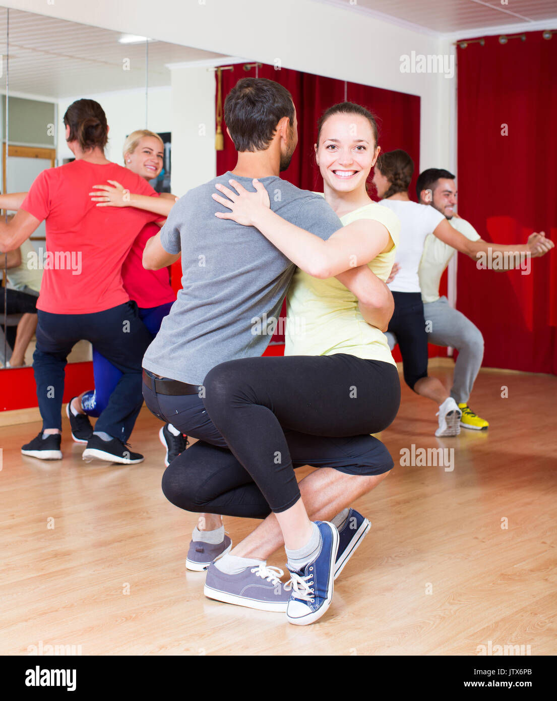 Group of happy people dancing salsa in studio Stock Photo - Alamy