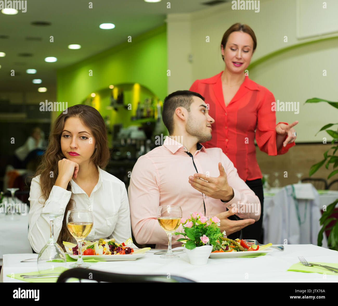 Unpleased man talking with polite manager in restaurant Stock Photo - Alamy