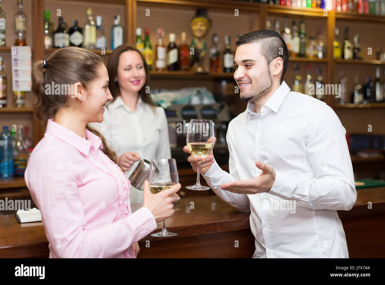 Small bar with female barista and two clients at counter Stock Photo ...
