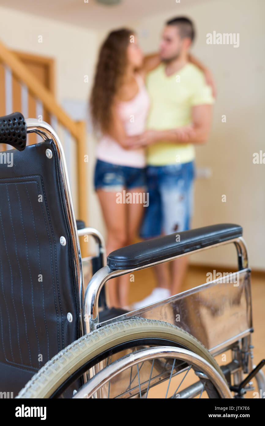 Caregiver helps handicapped girl to ambulate without invalid chair ...
