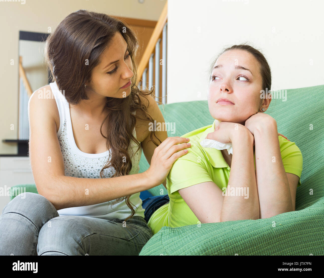 Young american woman calms a crying friend Stock Photo - Alamy