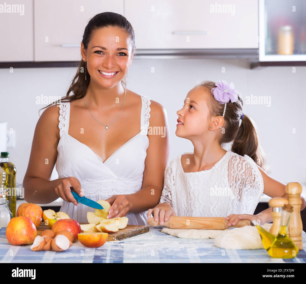 Portrait of happy woman and child cooking apple strudel Stock Photo - Alamy