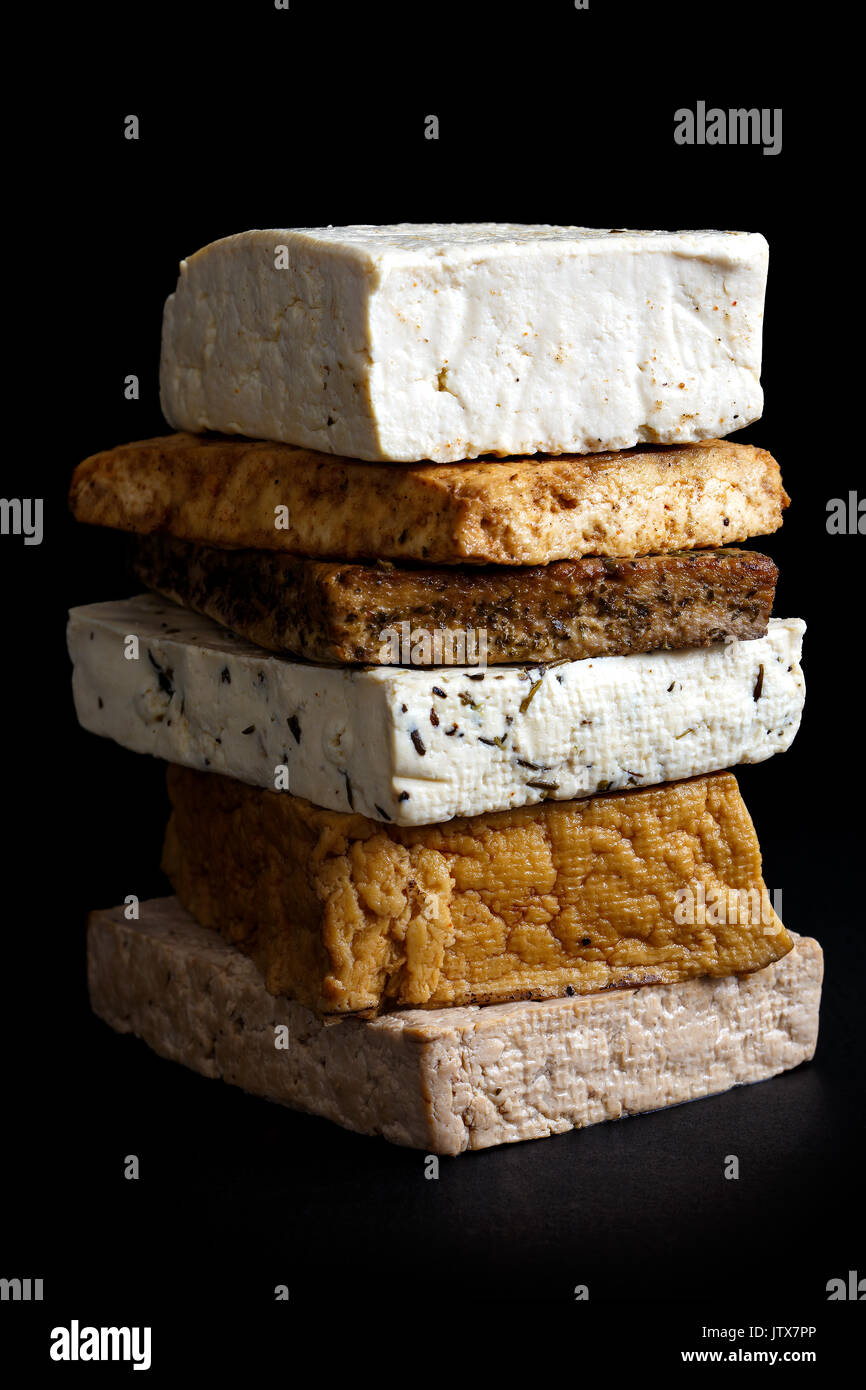 Stack of mixed tofu blocks isolated on black Stock Photo - Alamy