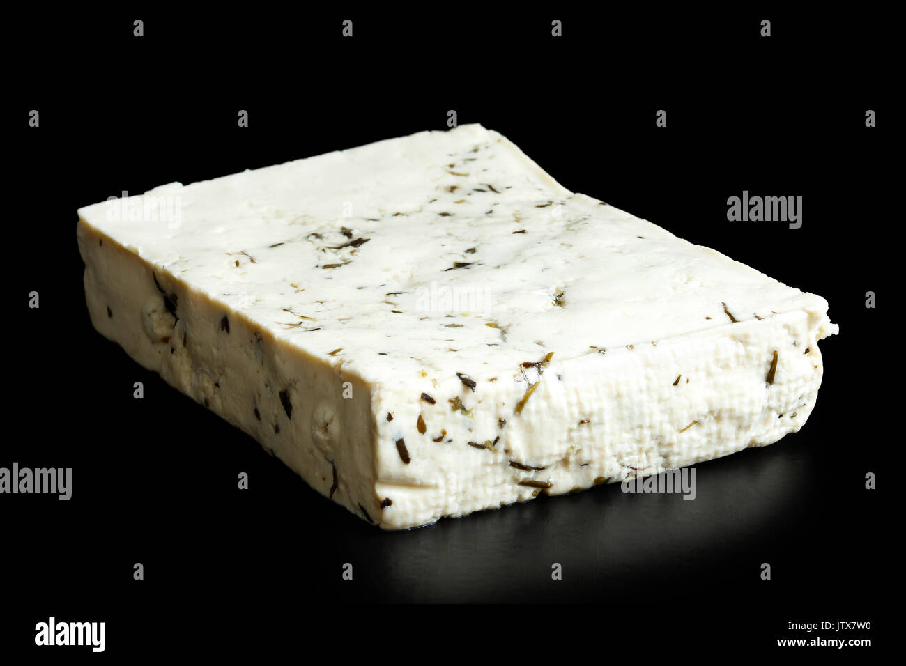 Single block of natural tofu with herbs isolated on black Stock Photo ...