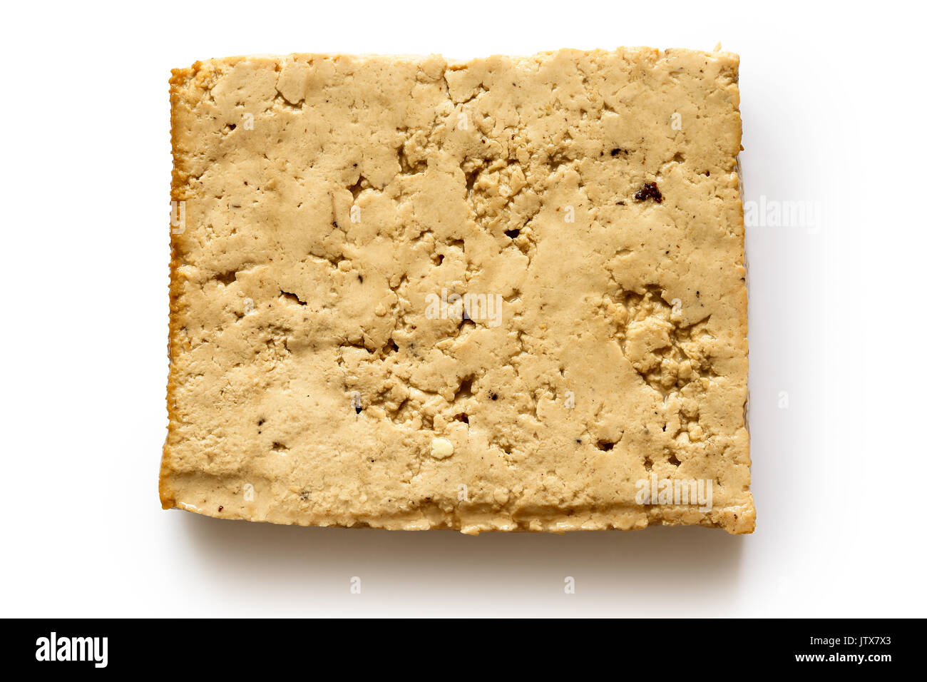 Single block of lightly smoked tofu isolated on white from above Stock ...
