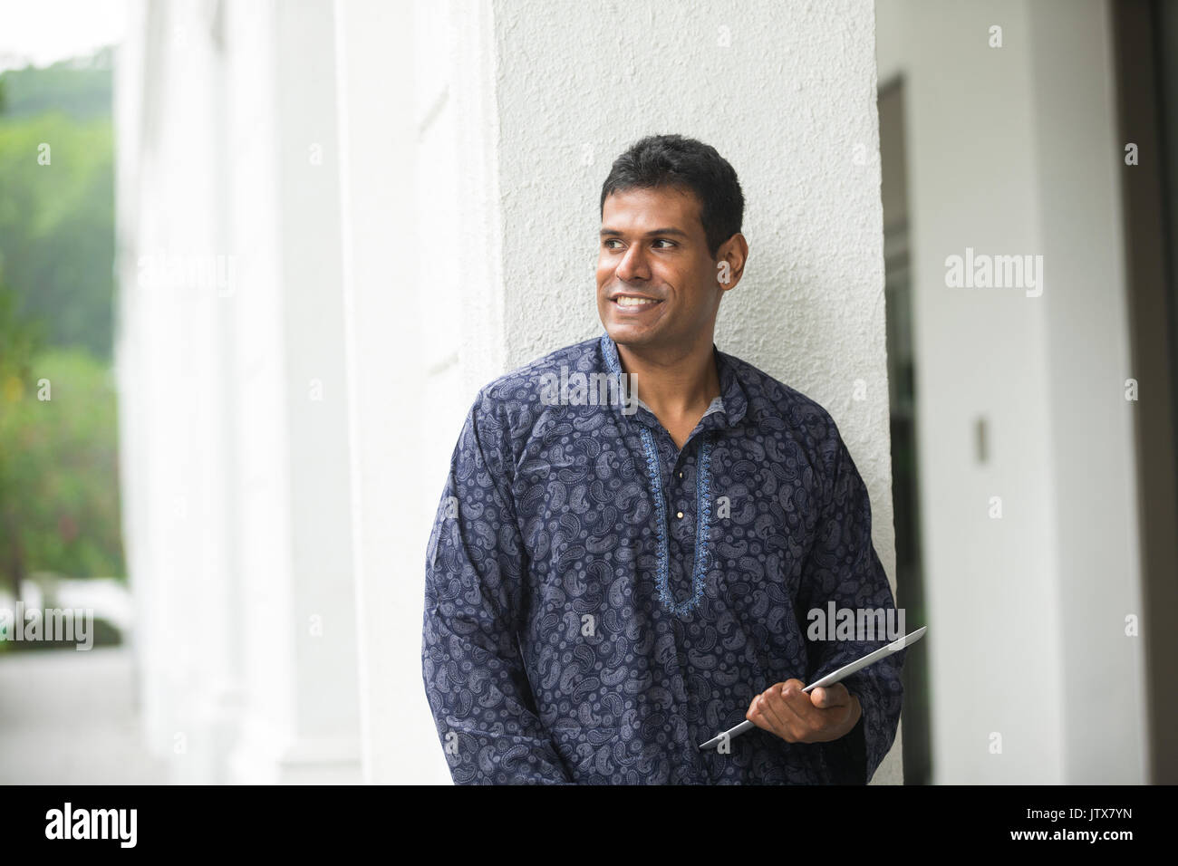 Happy indian man outdoors. portrait of an indian man wearing a ...