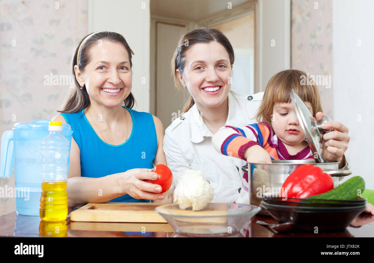 Happy family cook with vegetables in the kitchen Stock Photo - Alamy
