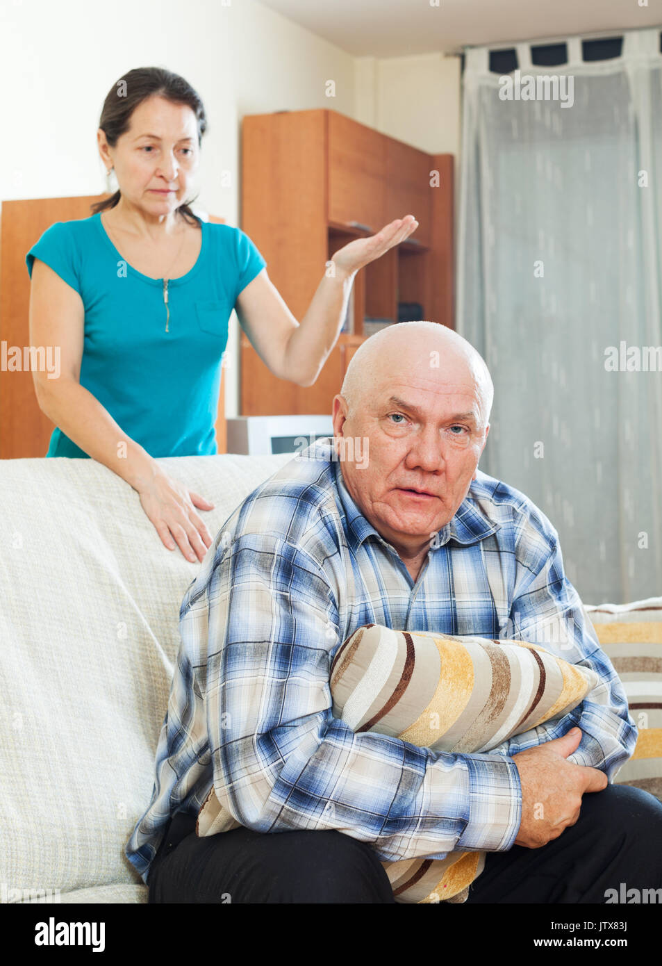 Family quarrel. Unhappy senior man with angry wife at home Stock Photo ...