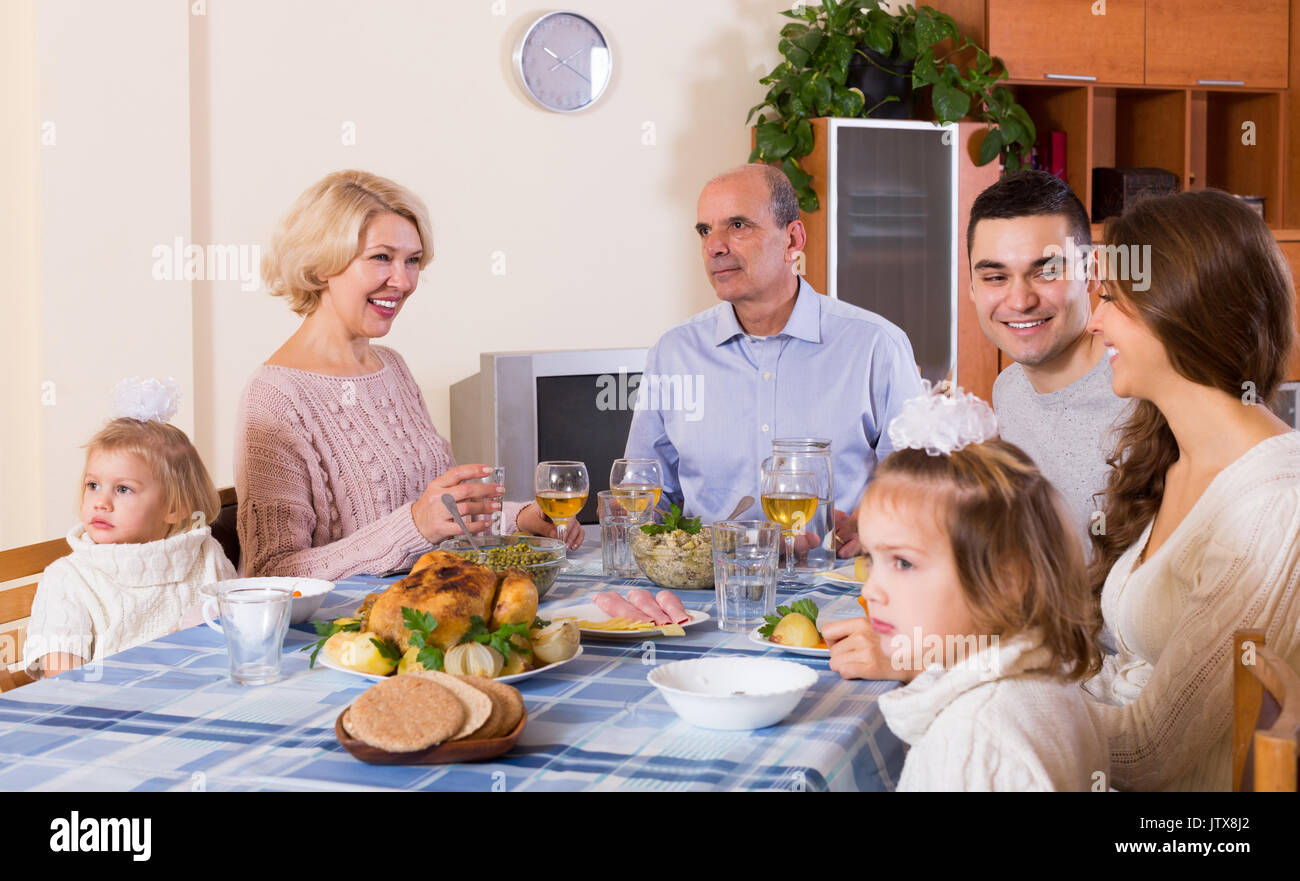 Portrait of smiling big family at the dining table indoor Stock Photo ...
