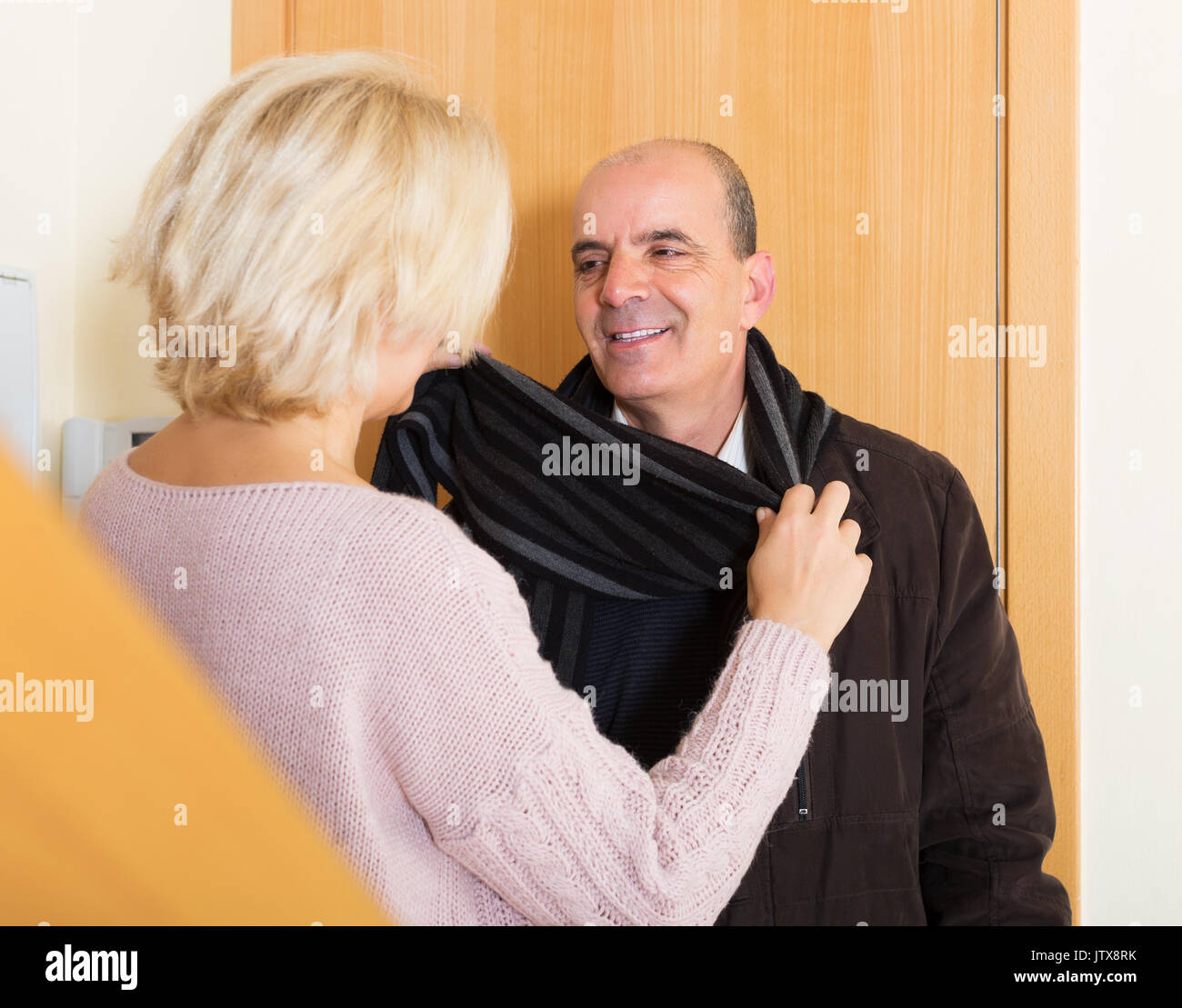 Portrait of loving spouses saying goodbye at doorway Stock Photo - Alamy