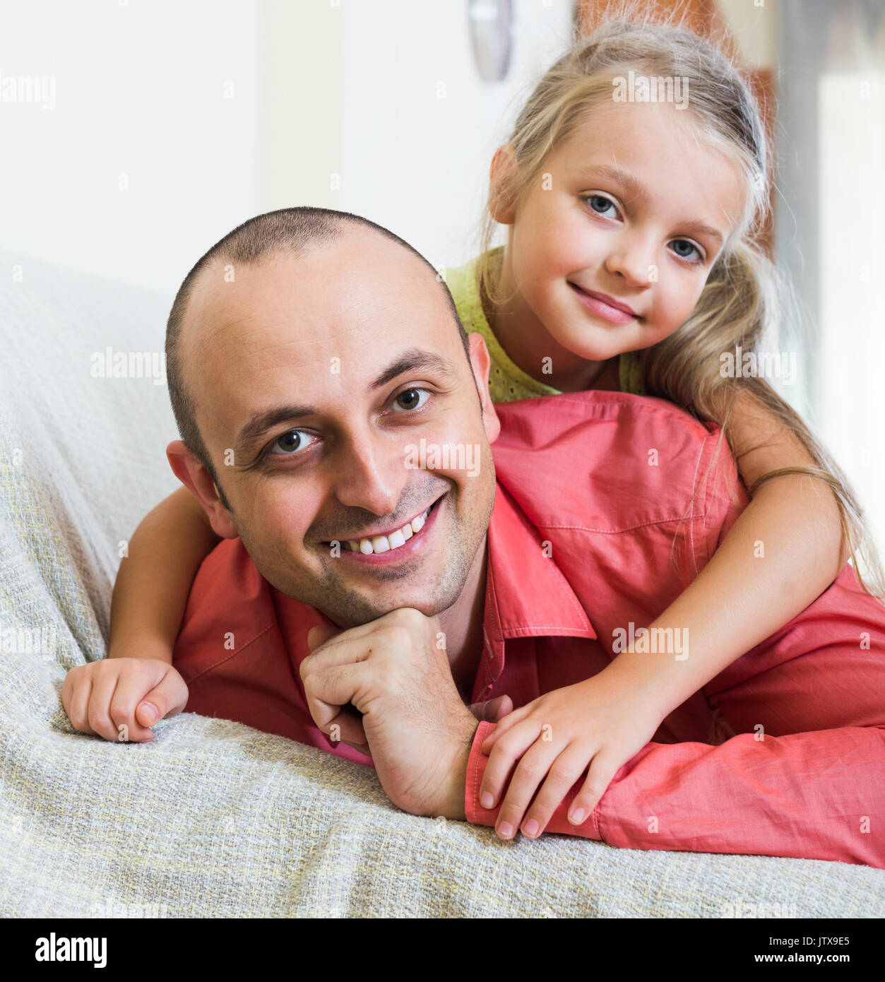 Happy russian father and little daughter posing in domestic interior ...