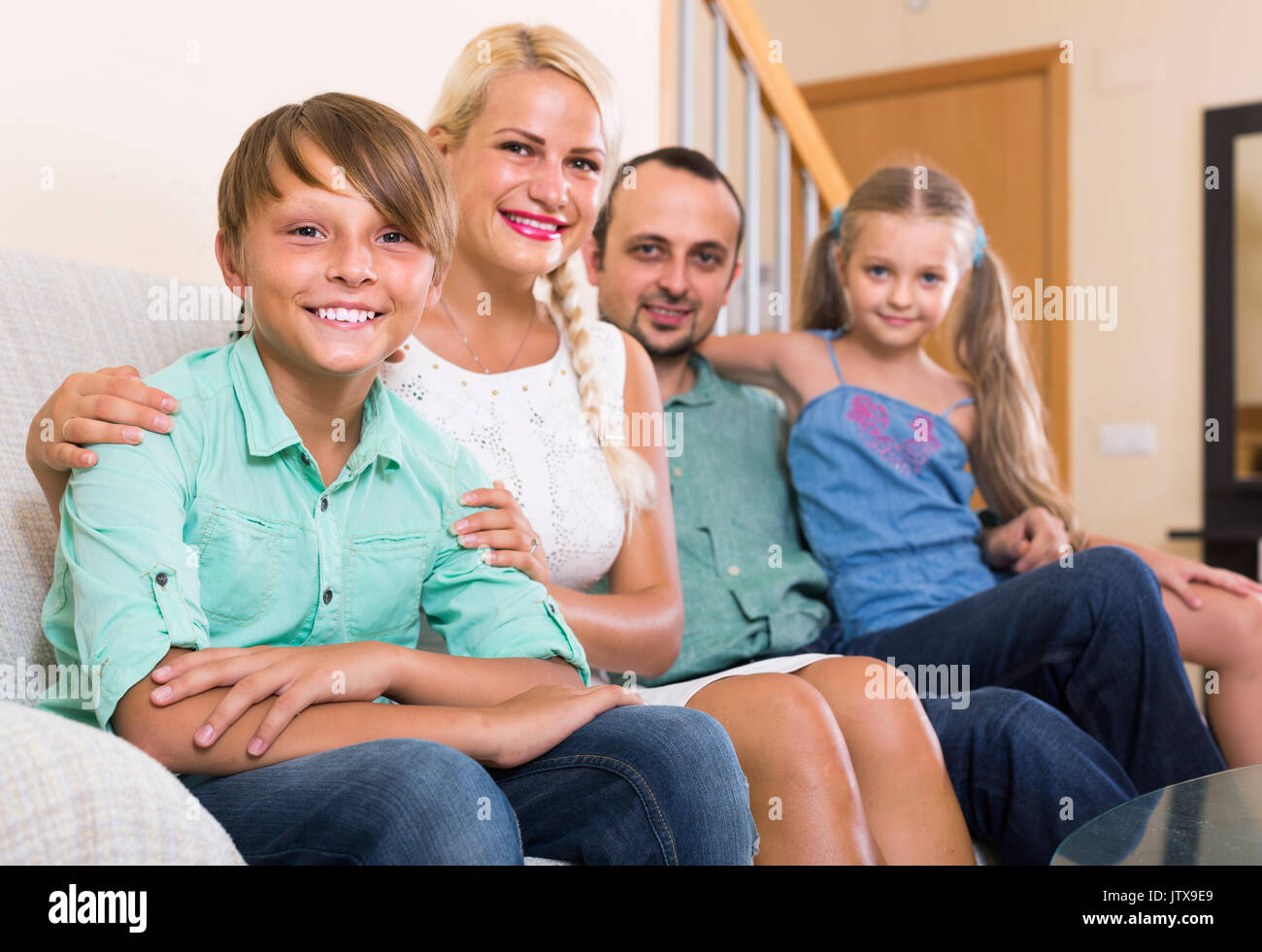 adult american parents with two children posing in home interior Stock ...