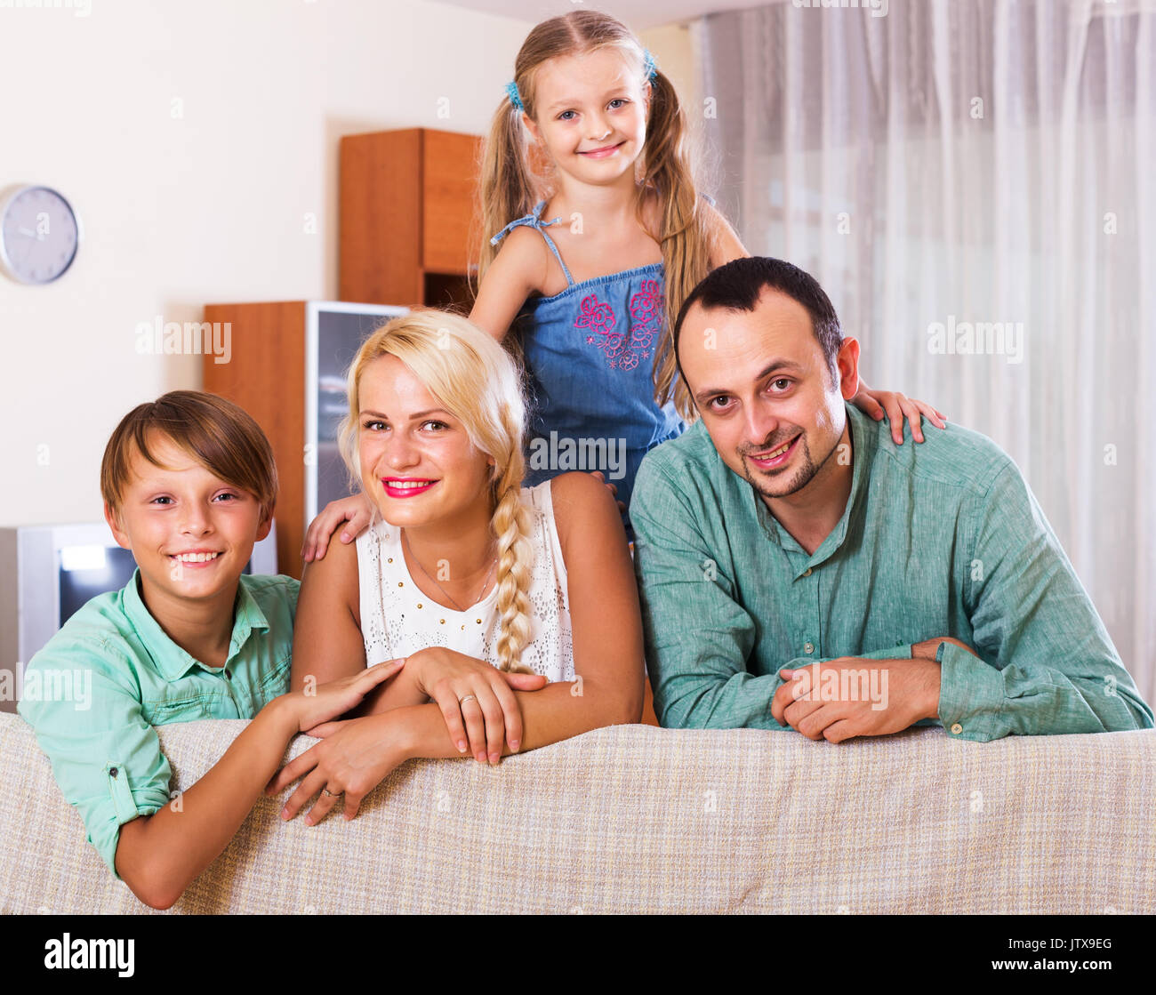 Portrait of smiling middle class caucasian family with two children at ...