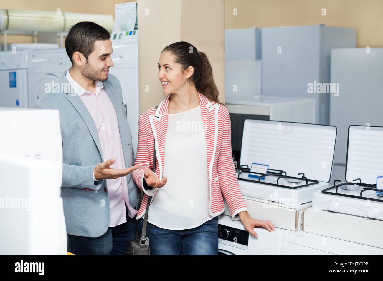 Cheerful young customers at small domestic appliances section Stock ...
