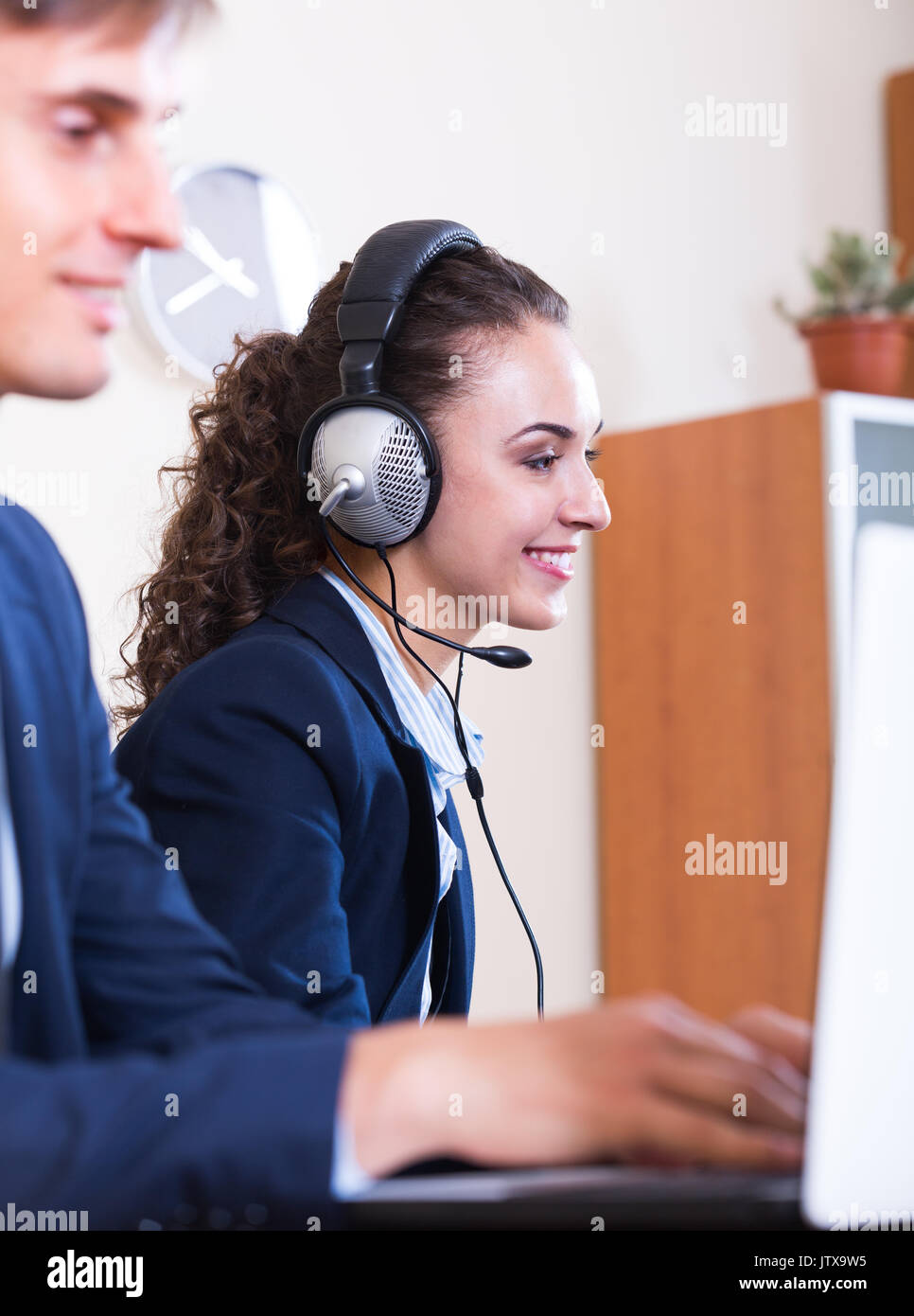 Portrait of two happy help line operators at workplace Stock Photo - Alamy