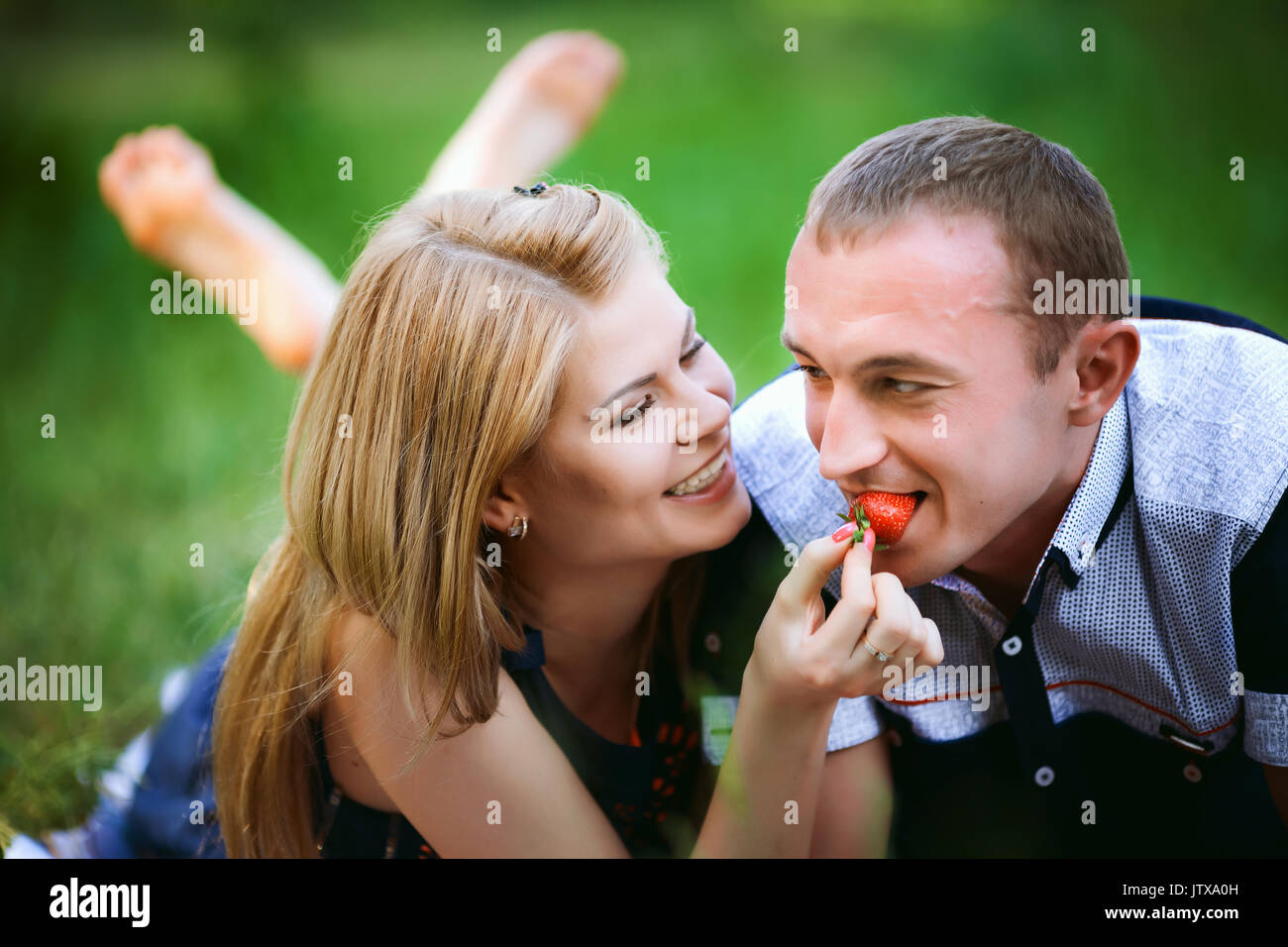 woman feeding man a strawberry Stock Photo - Alamy