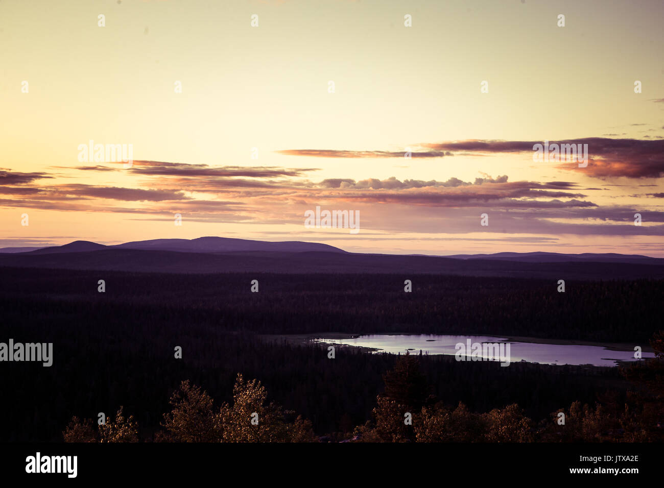 A beautiful landscape with a midnight sun above arctic circle. Dreamy ...