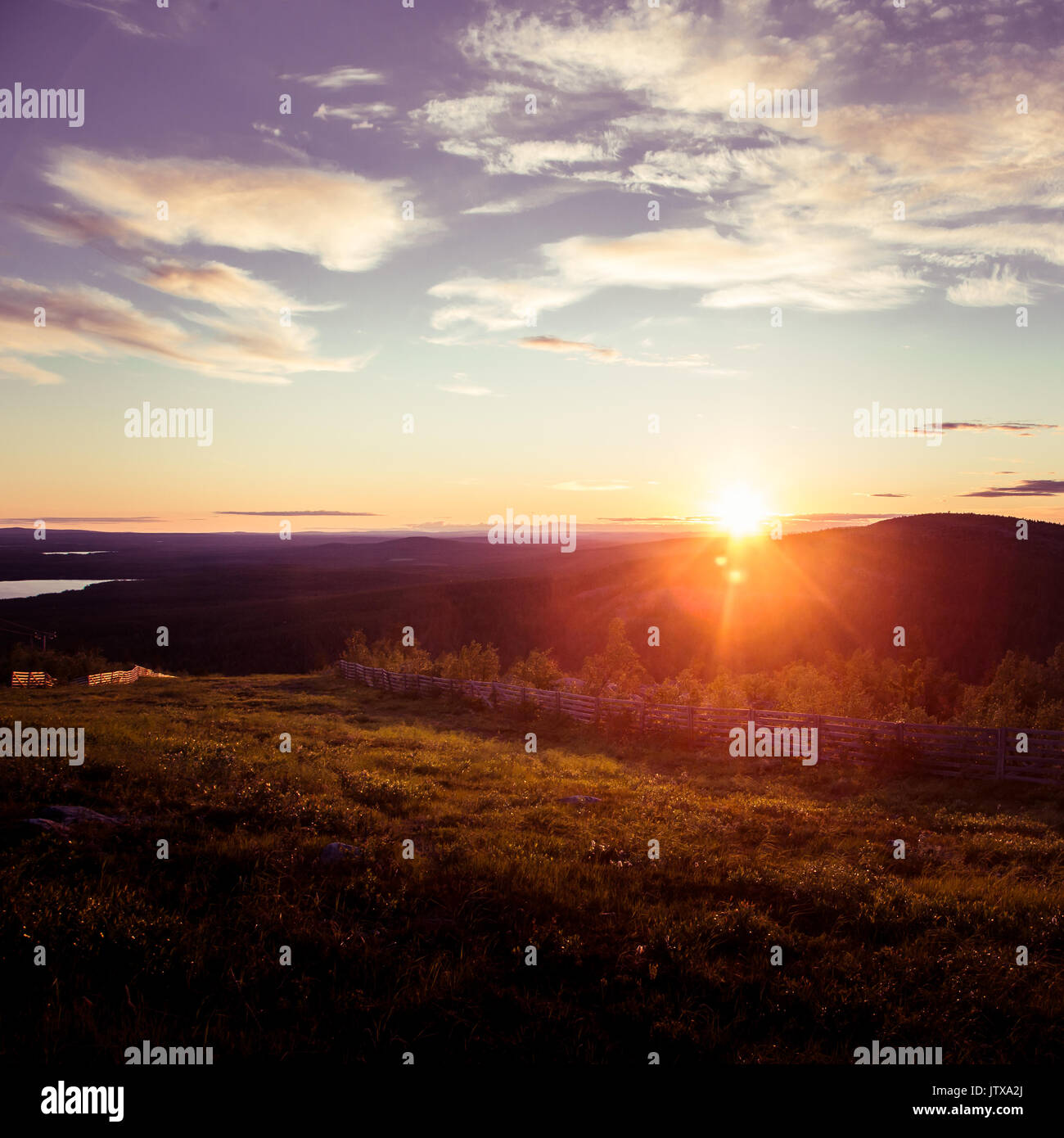 A beautiful landscape with a midnight sun above arctic circle. Dreamy ...