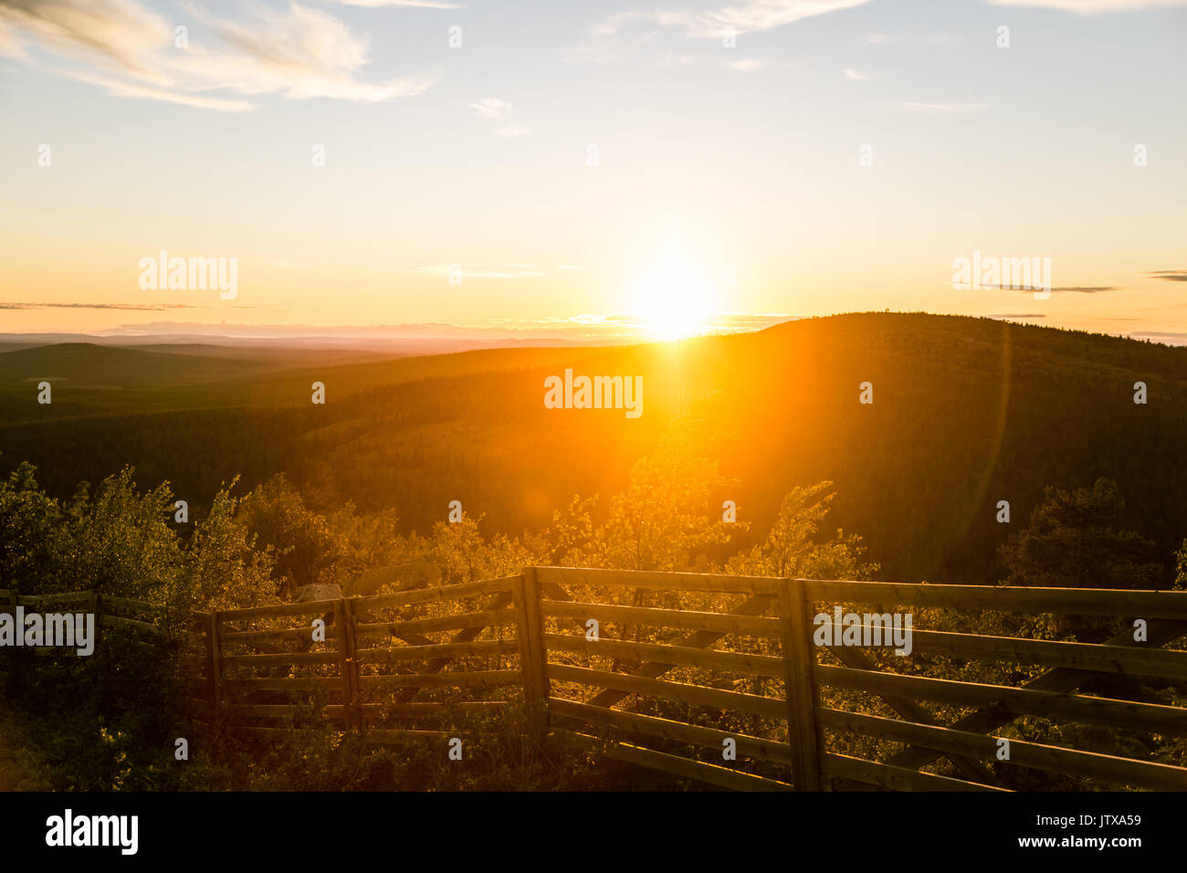 A beautiful landscape with a midnight sun above arctic circle. Dreamy ...