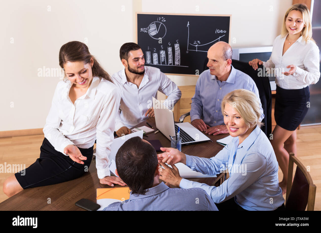 Portrait of friendly relaxed employees having break Stock Photo - Alamy