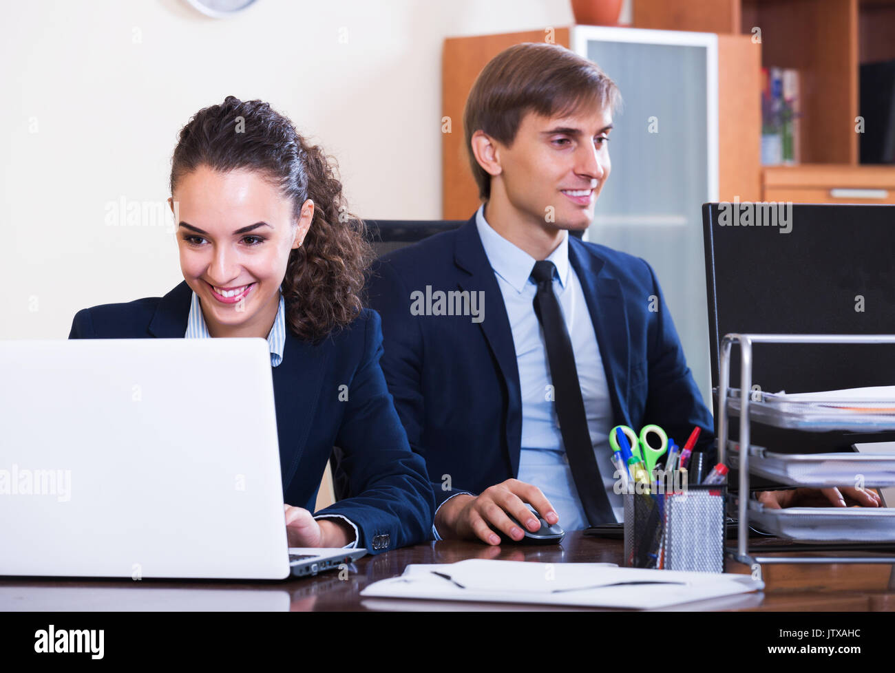 Happy office colleagues successfully working together and smiling Stock ...