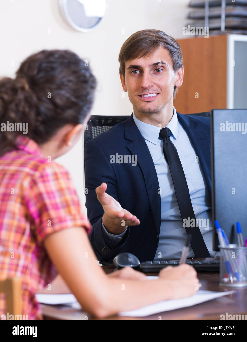 Banking agent offering young hi-res stock photography and images - Alamy