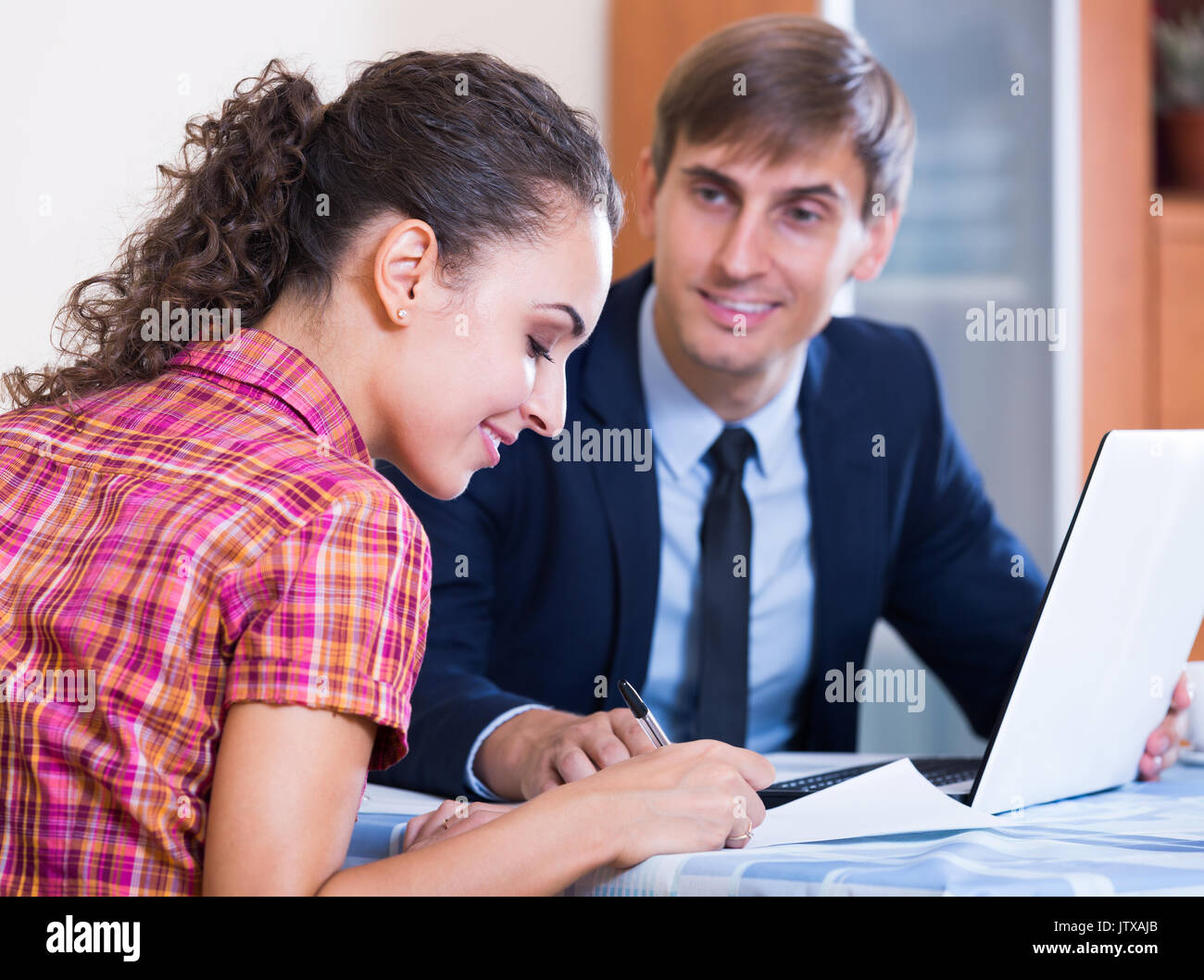 Banking happy spanish agent with nice offer consulting customer indoors ...